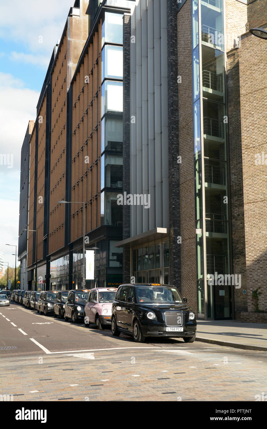 Queue of black cab London taxis on Pancras Road next to St Pancras ...