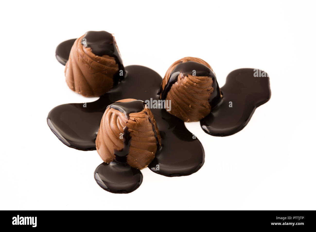 pieces of bonbons covered with melted chocolate isolated on white ...