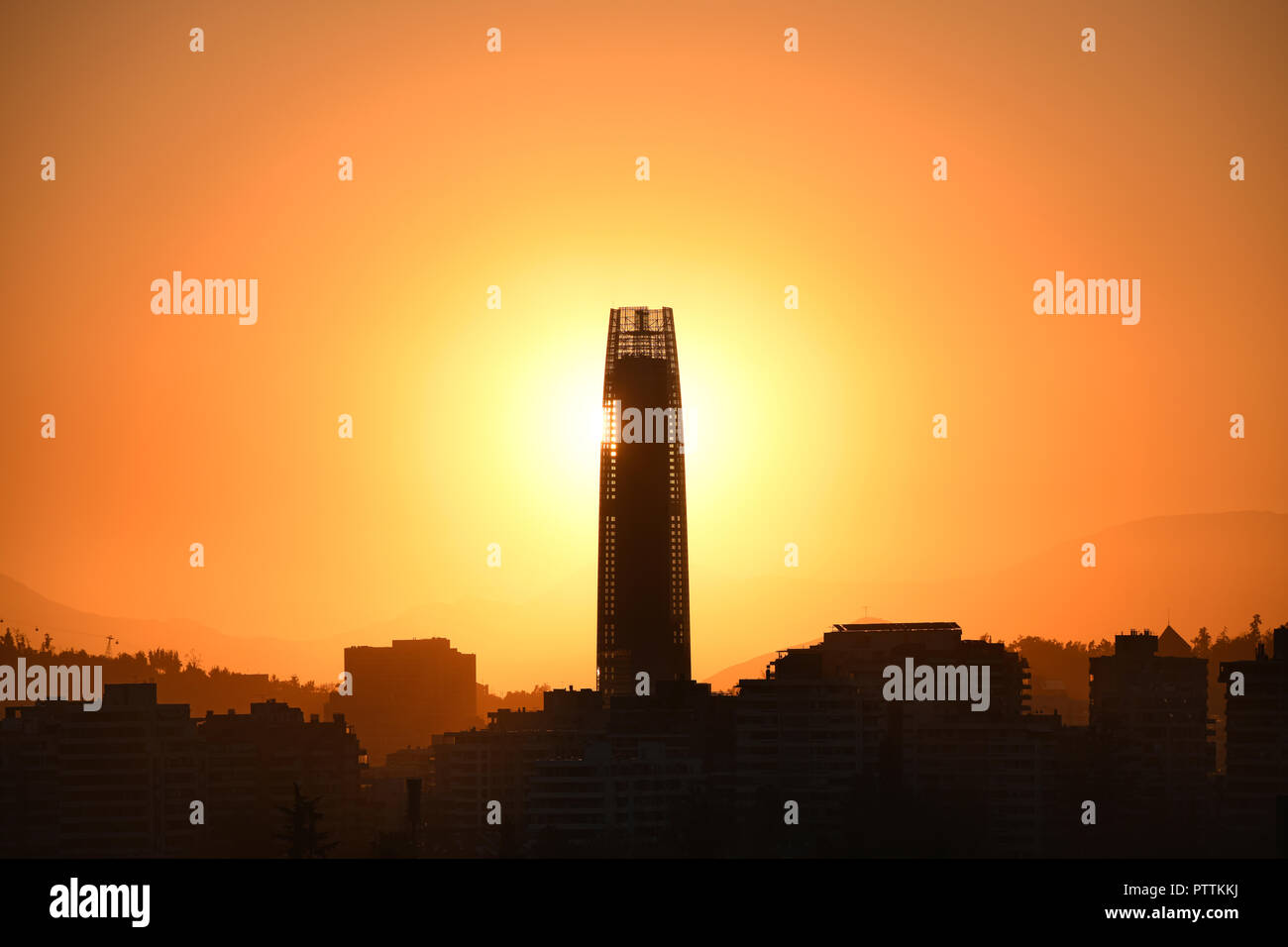 Sun setting behind a skyscraper in Santiago de Chile Stock Photo - Alamy