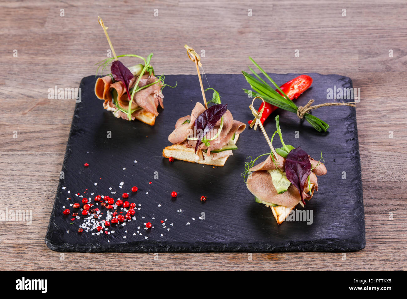 Beef canape served green onion Stock Photo - Alamy