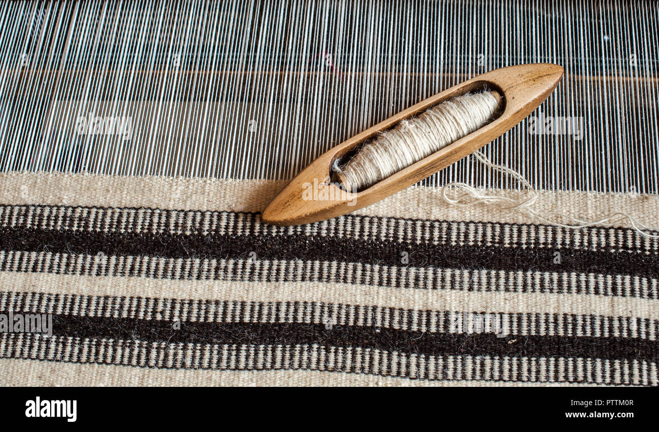 Weaving loom and shuttle on the warp. Weaving background and sample ...