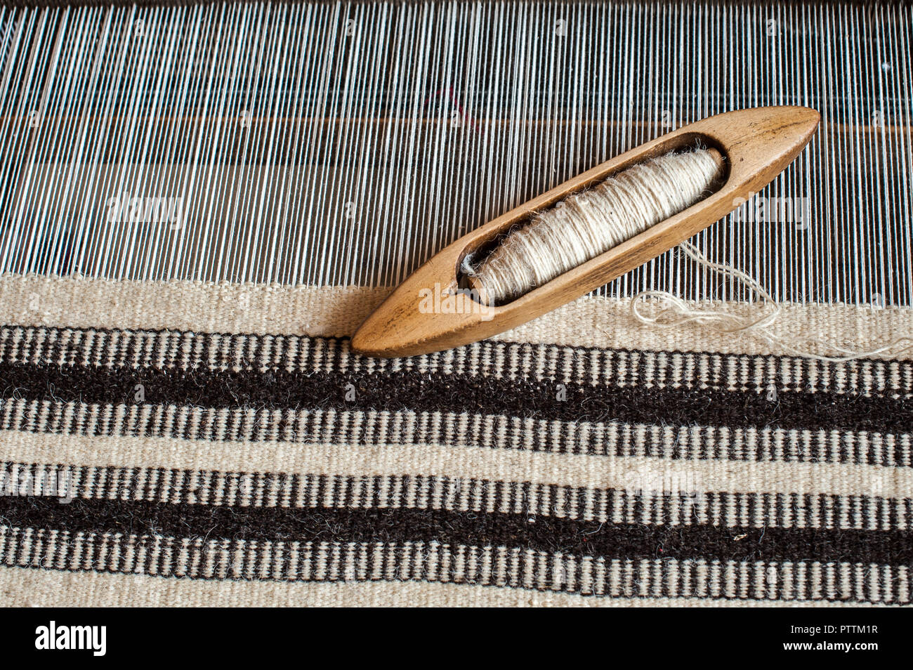 Weaving loom and shuttle on the warp. Weaving background and sample ...
