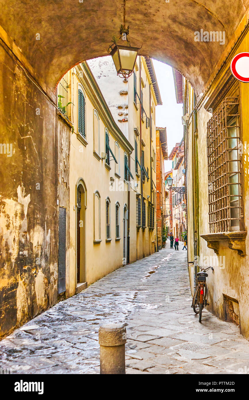 LUCCA, ITALY - APRIL 30, 2013: The narrow medieval street in the heart ...