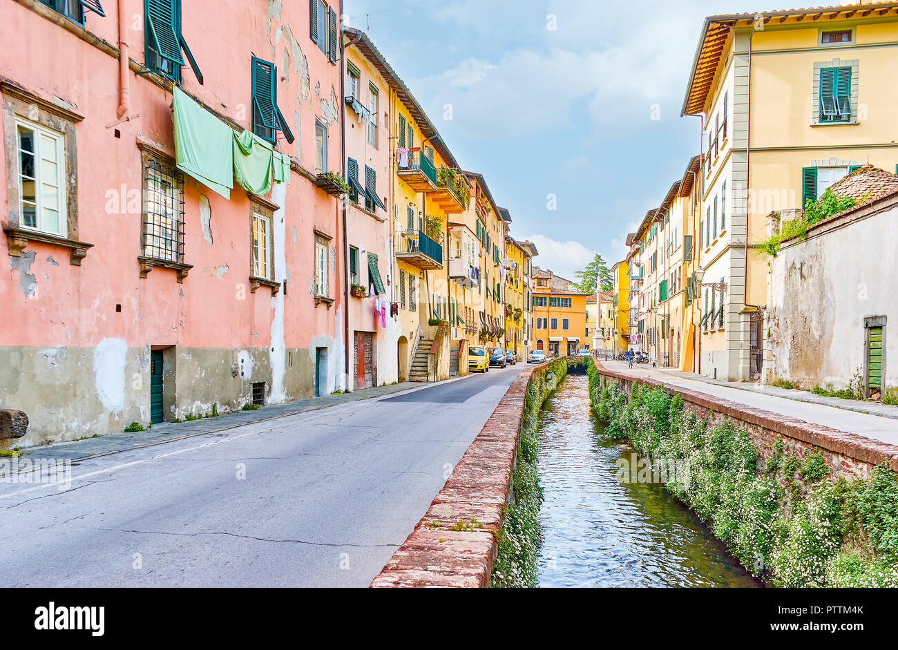 The classic Italian old street with drying cloths on the balconies and ...