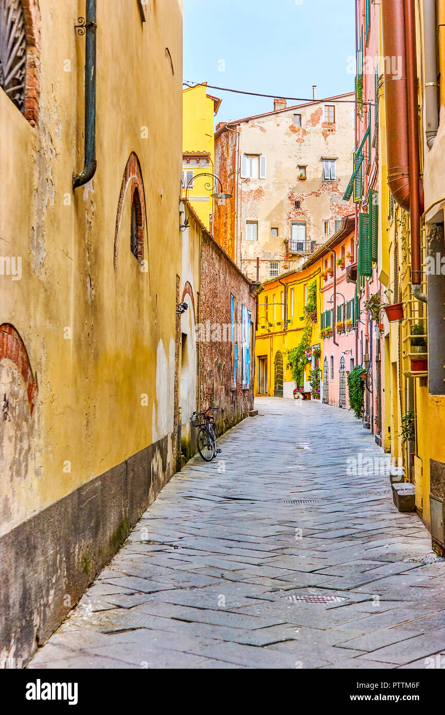 The walk in old Italian town along narrow winding streets with dense ...