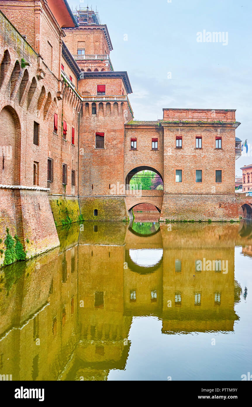 The wide dug moat surround Castlello Estense, the medieval fortress in ...
