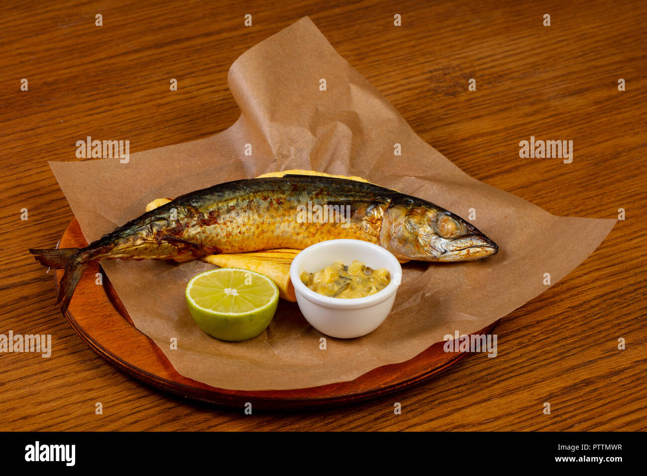 Smoked scomber fish with sauce and lime Stock Photo - Alamy