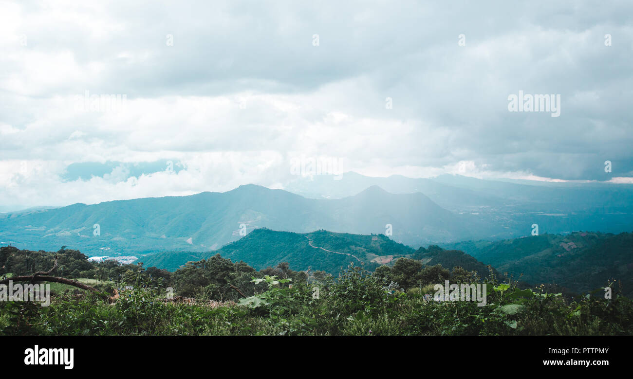 Picturesque mountain landscape and rain clouds in the lush countryside ...