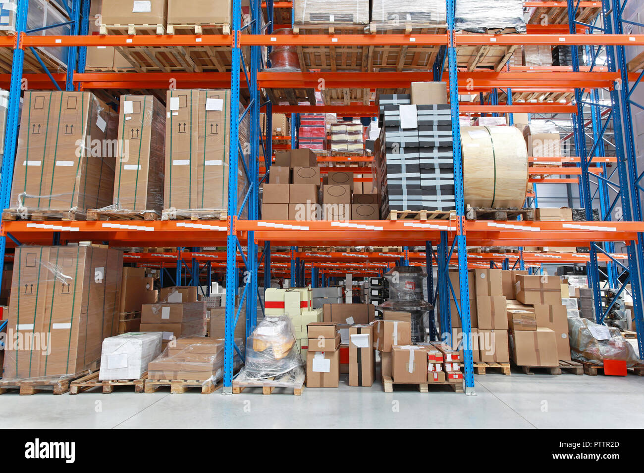 Shelving system with goods in distribution warehouse Stock Photo - Alamy