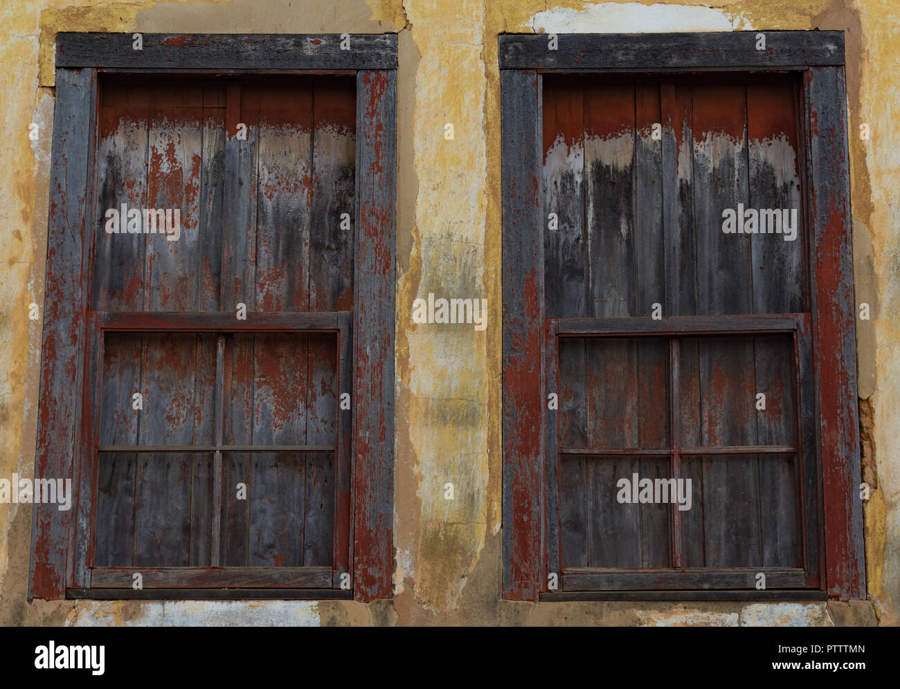 Old wooden windows, worn by the action of time, the colors yellow and ...