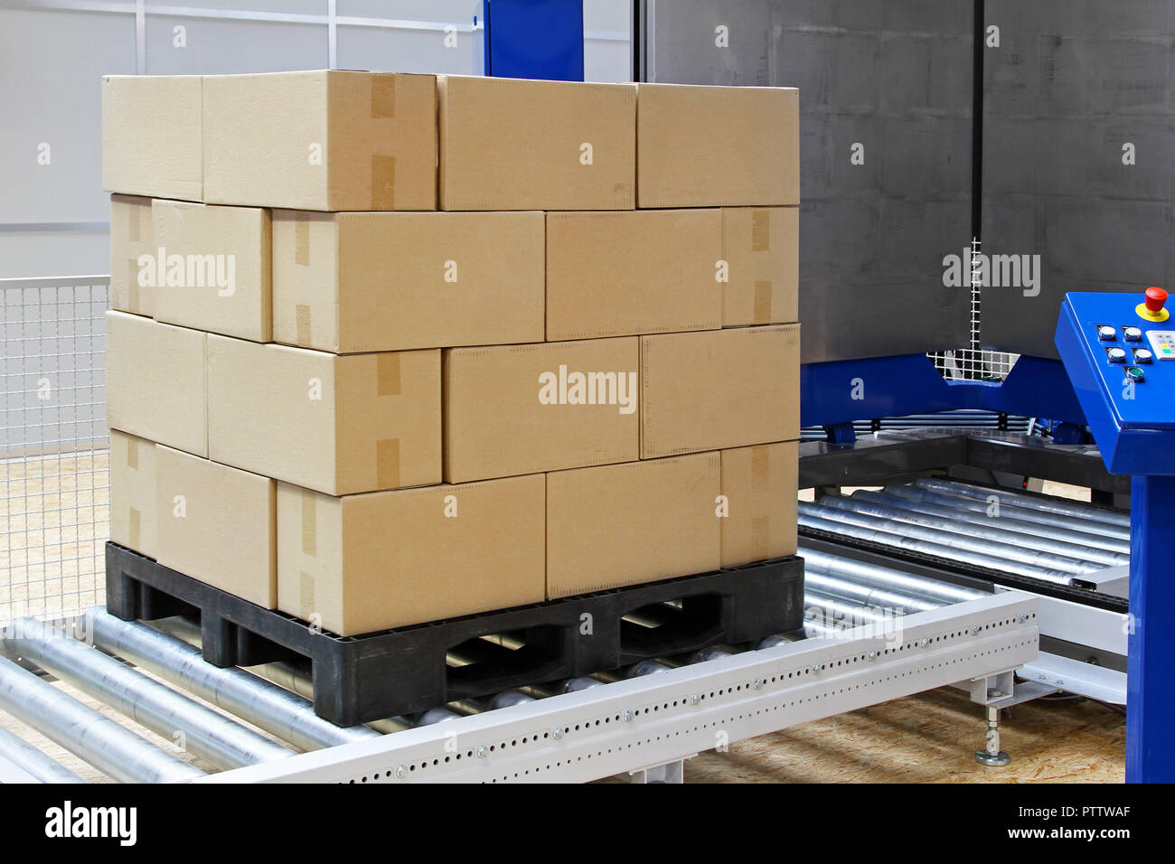 Cardboard boxes at transport pallet packer machine Stock Photo - Alamy