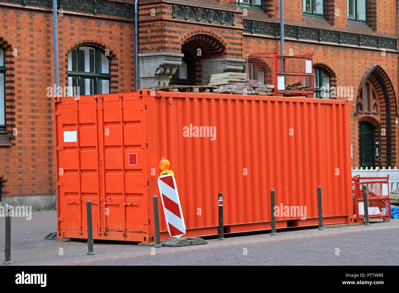 Orange cargo container at city street Stock Photo - Alamy