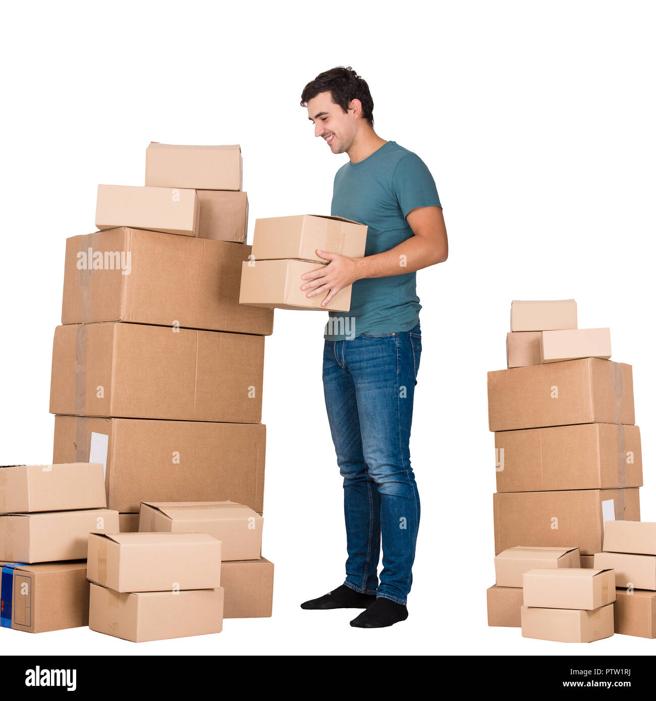 Full length portrait of young man packing stuff in boxes ready to move ...