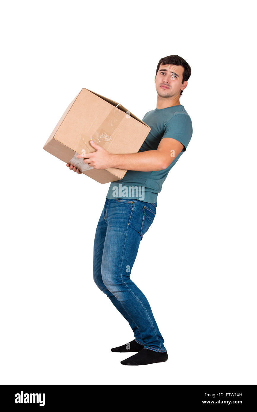 Frustrated young man lean back carrying a heavy box isolated on white ...
