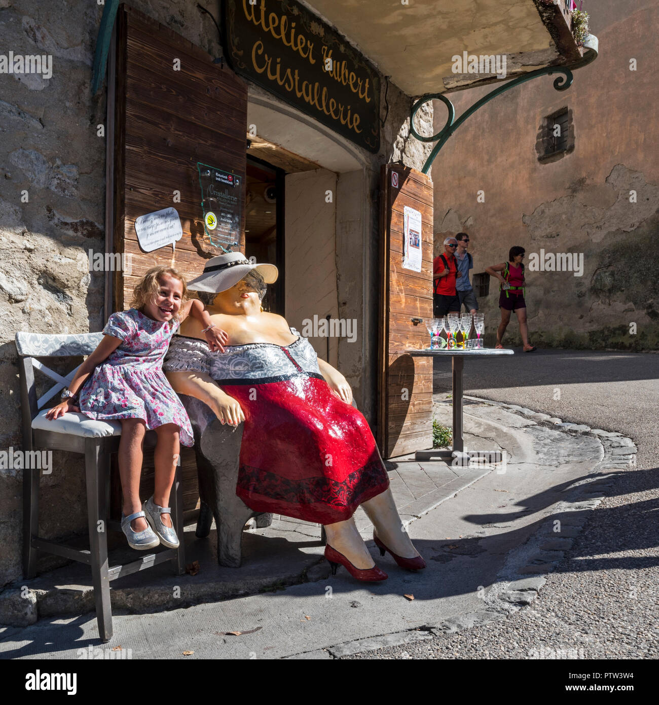Child posing in front of crystal shop Cristallerie Atelier Hubert in ...