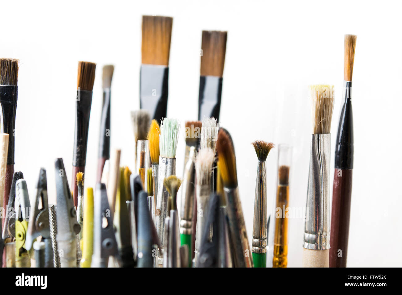 Different art equipment for painting with brushes and clips on white ...