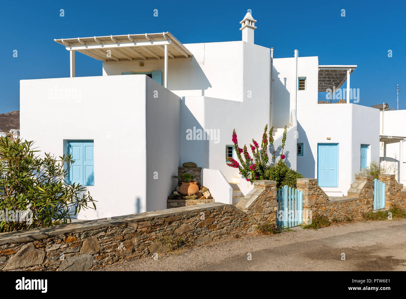 Beautiful cycladic architecture with whitewashed walls and blue doors ...