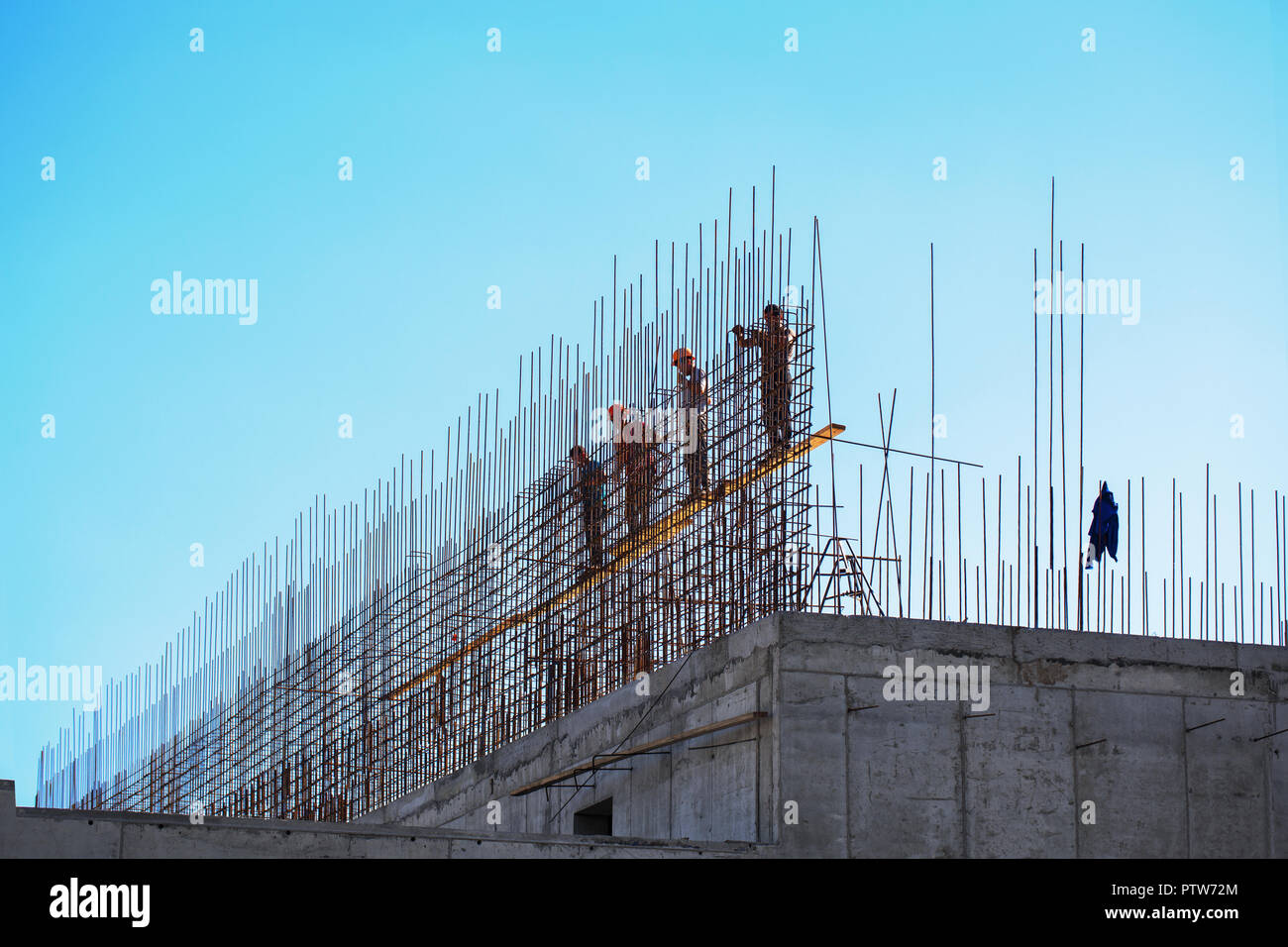 A group of workers working on the construction of a house Stock Photo ...
