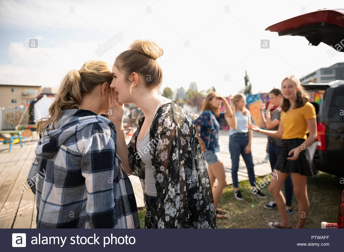 Girl whispering friend hi-res stock photography and images - Alamy