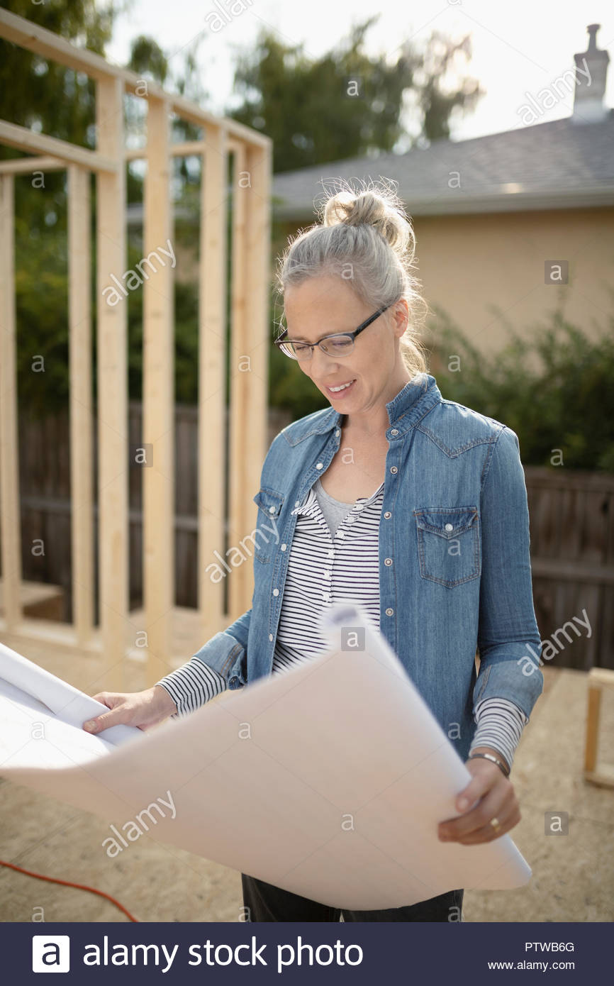 Female construction worker reading blueprints hi-res stock photography ...