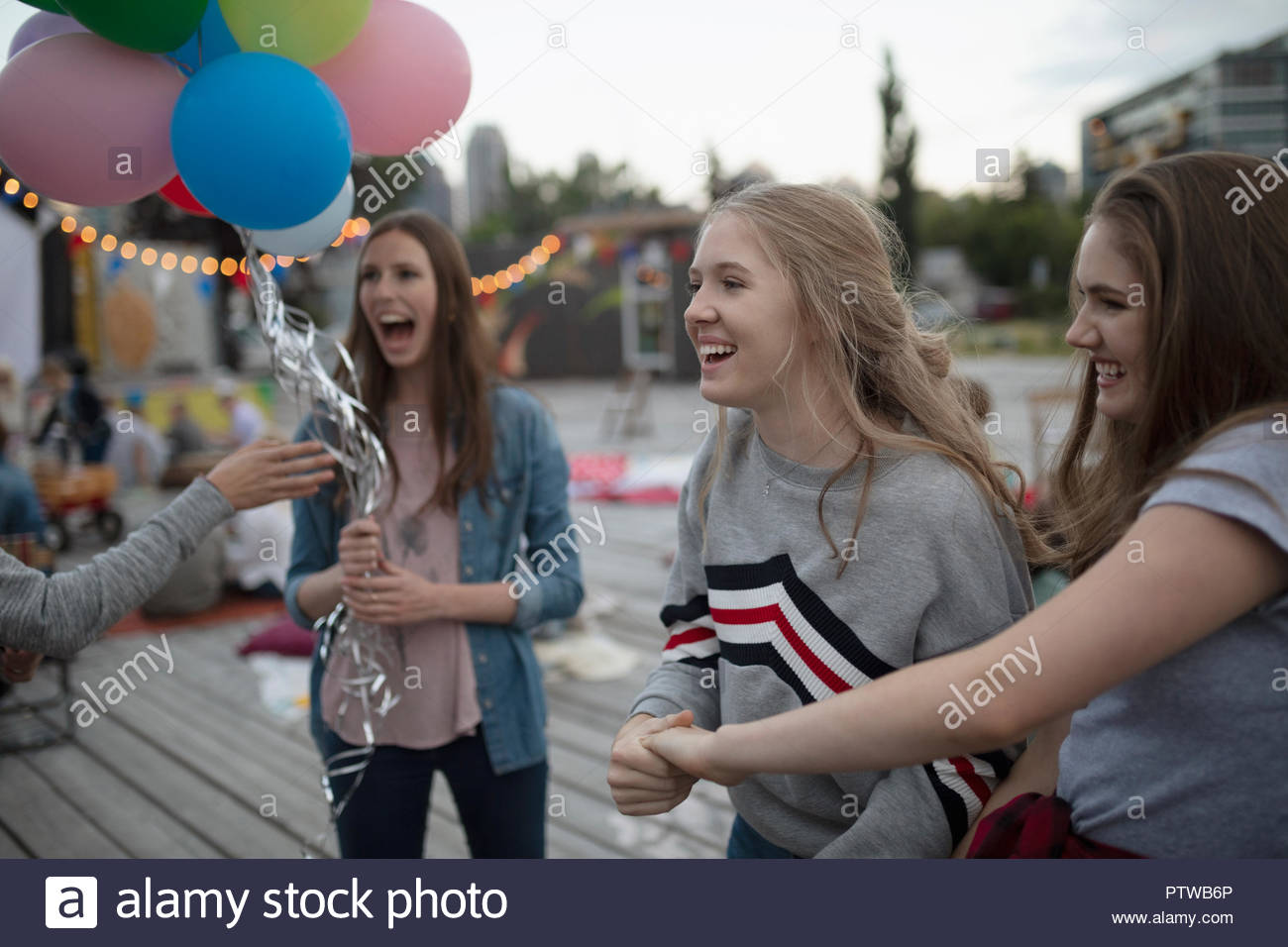 Teenage friends holding balloons hi-res stock photography and images ...