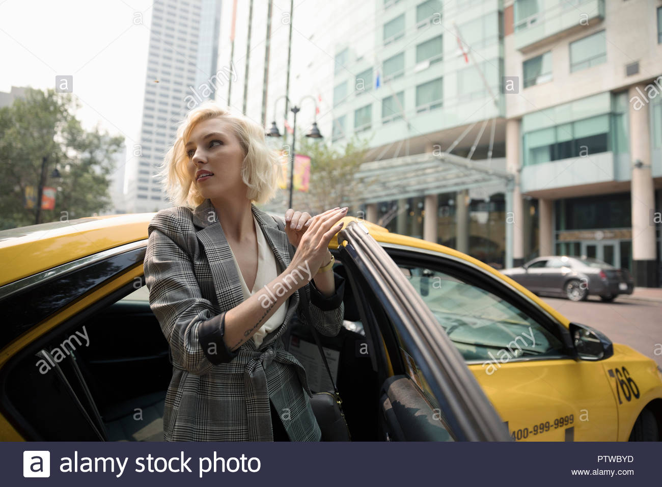 Woman getting a taxi hi-res stock photography and images - Alamy