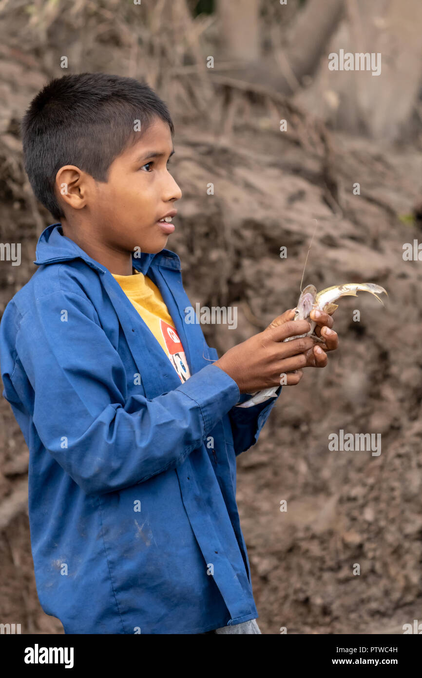 Amazon National Park, Peru, South America. Young boy who is showing off ...