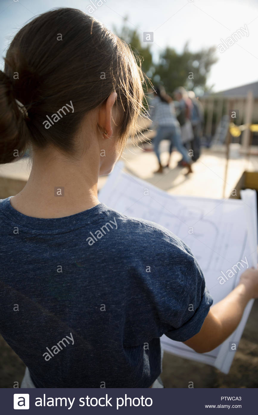 Female construction worker reading blueprints hi-res stock photography ...
