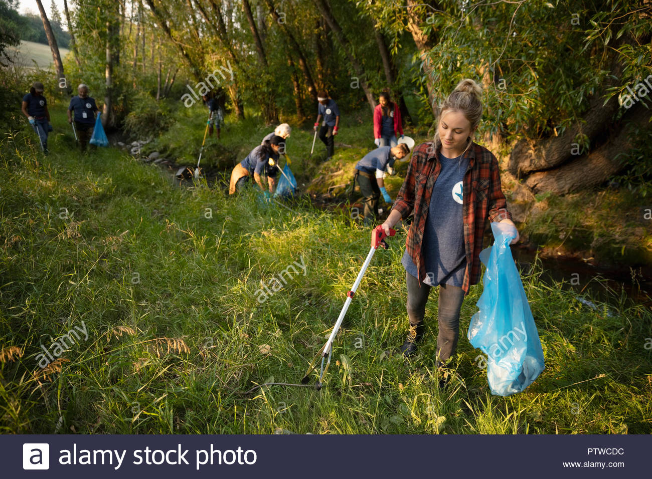 Woman picking up litter in hi-res stock photography and images - Alamy