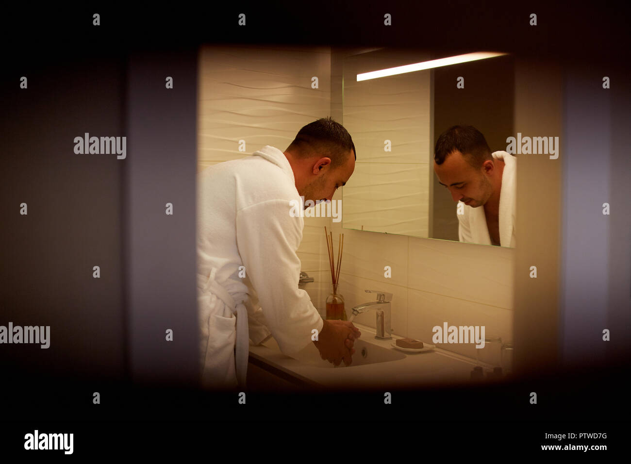 Man washes his face standing in the bathroom Stock Photo - Alamy