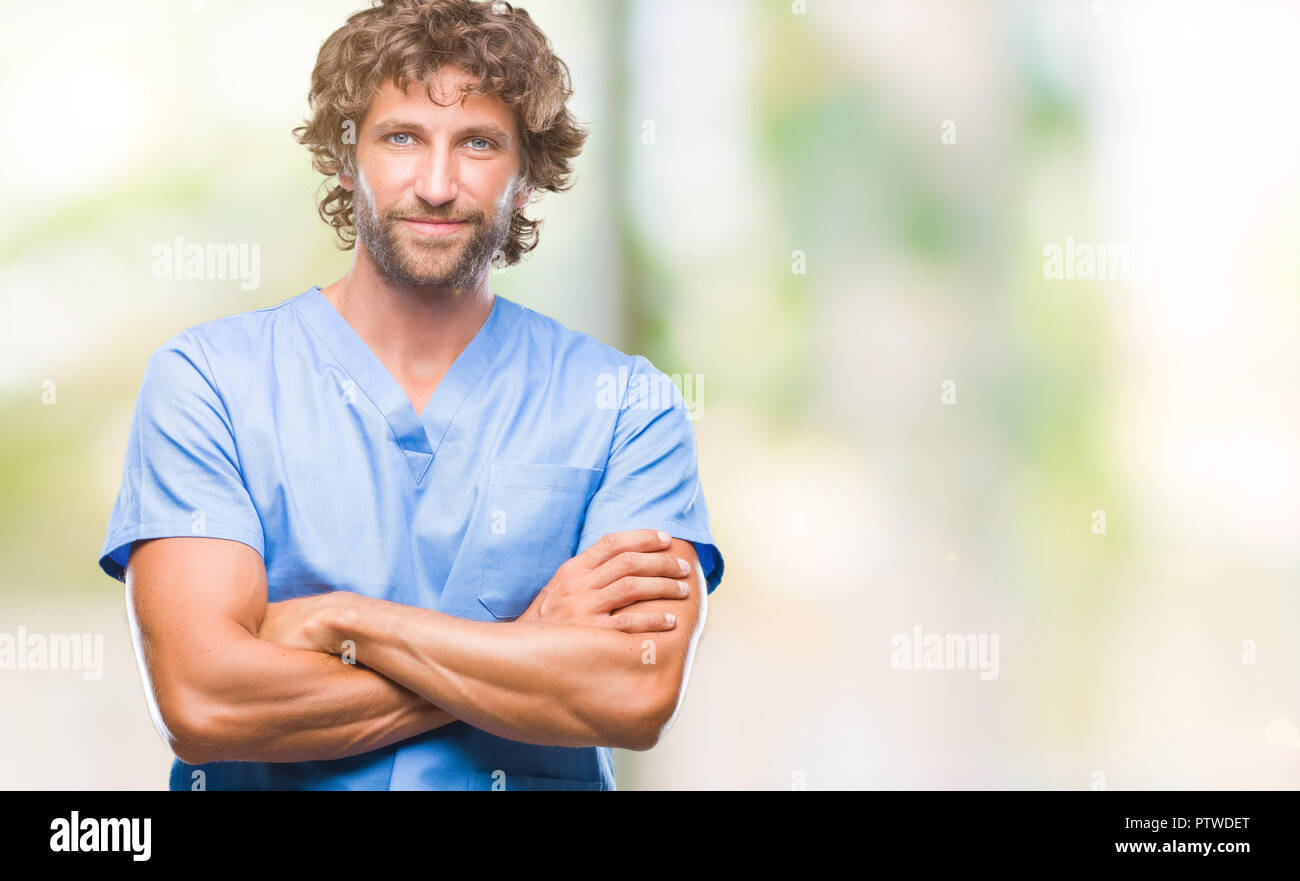 Handsome hispanic surgeon doctor man over isolated background happy ...