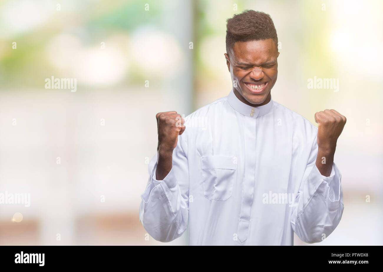 Young arabic african man wearing traditional djellaba over isolated ...