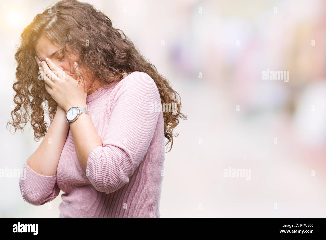 Beautiful brunette curly hair young girl wearing pink sweater over ...