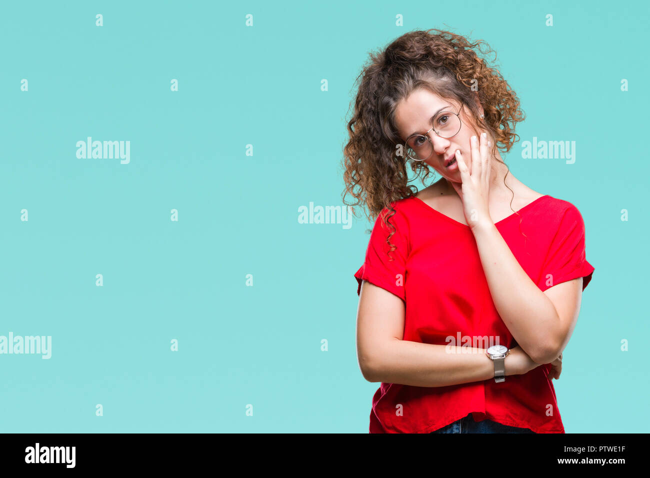 Beautiful brunette curly hair young girl wearing glasses over isolated ...