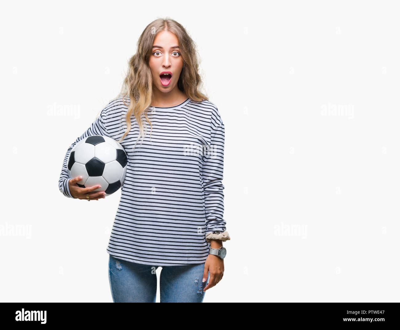 Beautiful young blonde woman holding soccer football ball over isolated ...