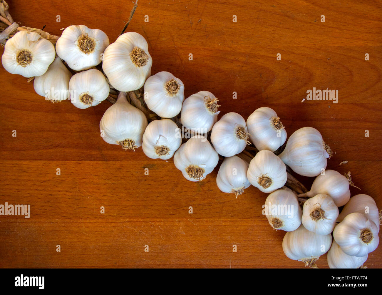 Garlic, on a wooden background, connected in an old fashioned way Stock ...