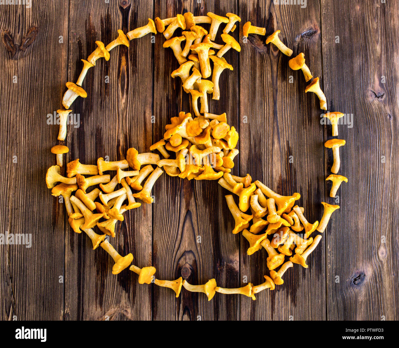 Radiation sign mushrooms chanterelles on a wooden background, fungi and ...