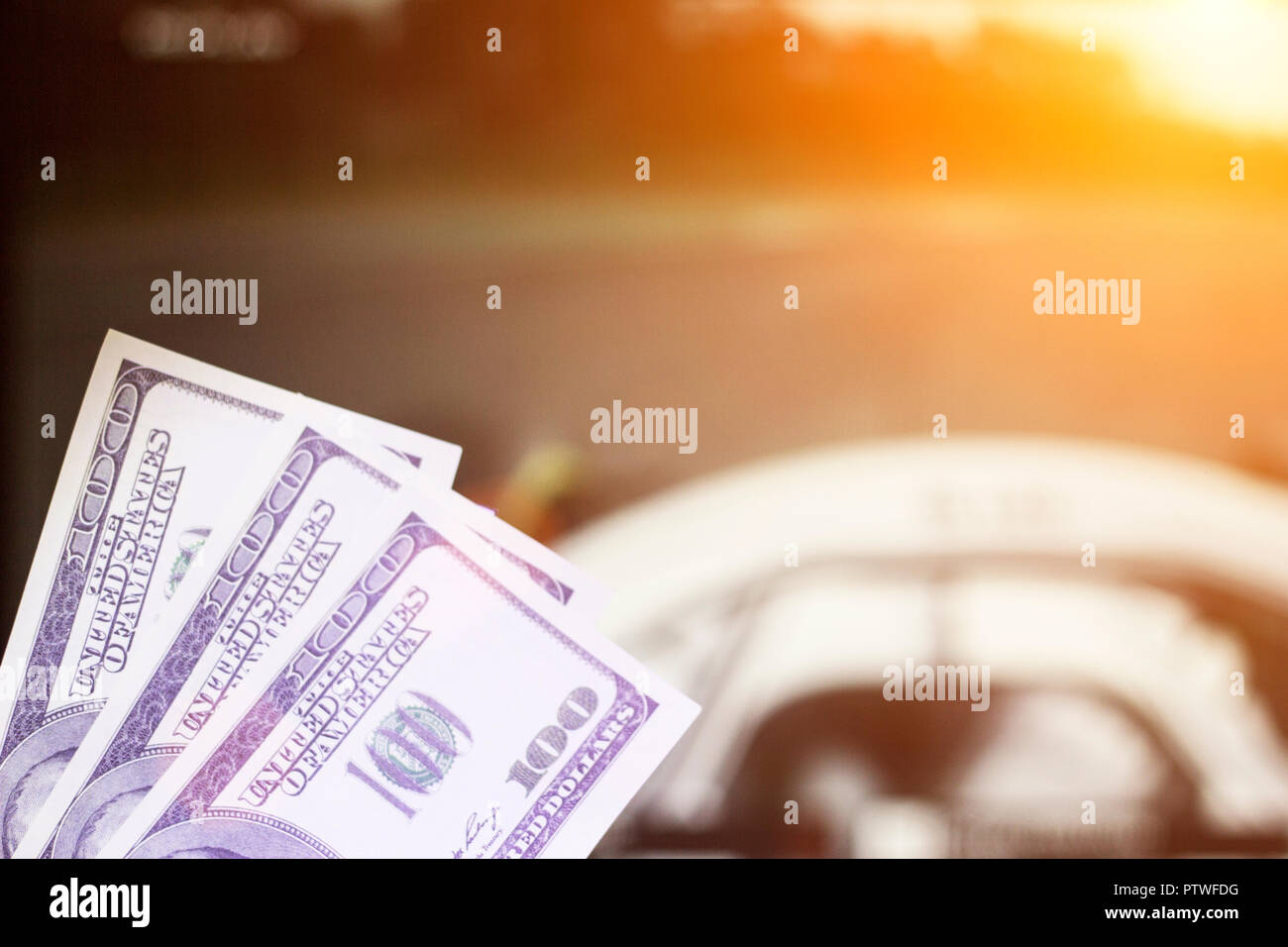 money dollars on the background of the TV on which go the auto racing ...
