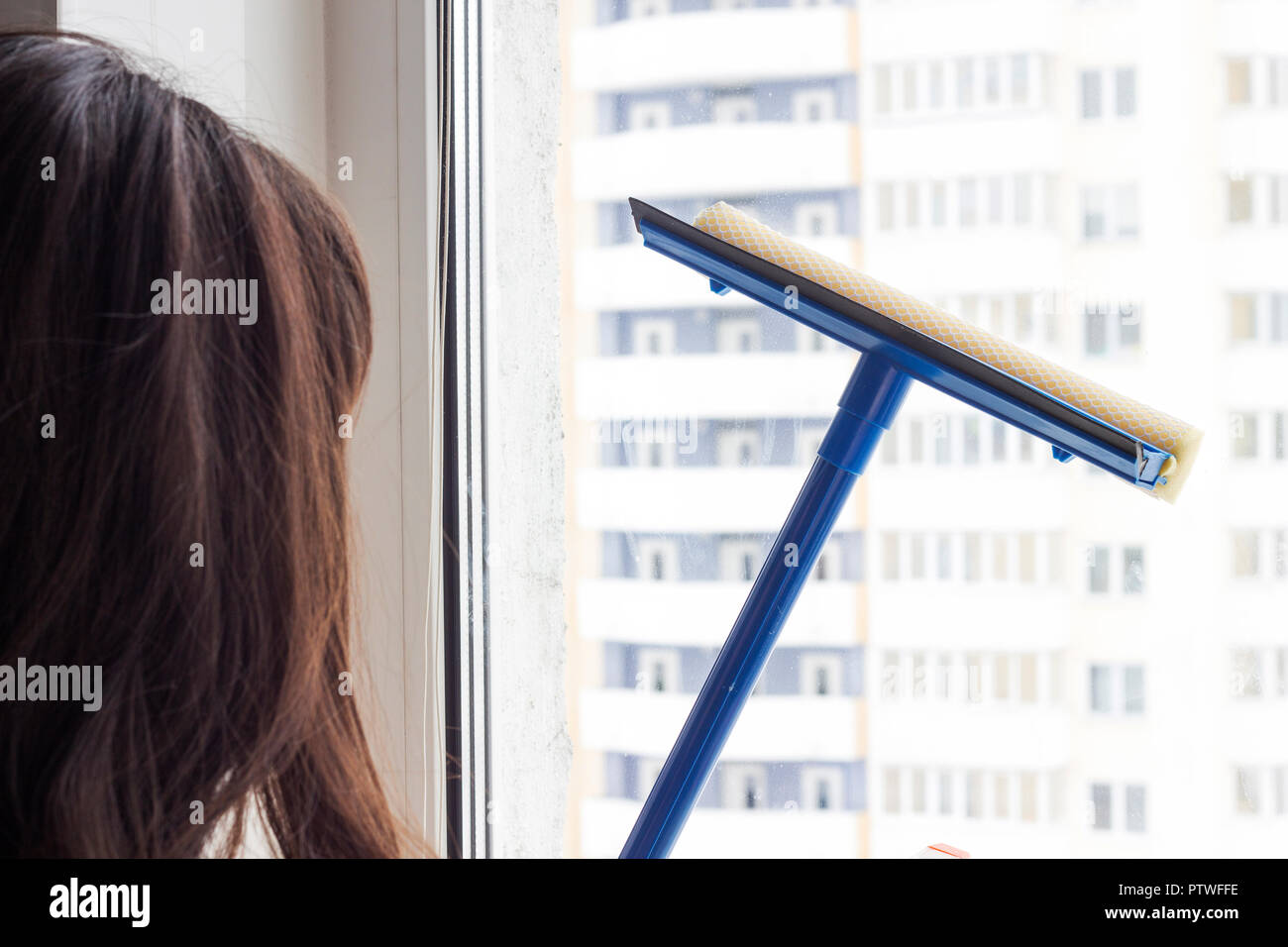 the girl washes the window, close-up Stock Photo - Alamy