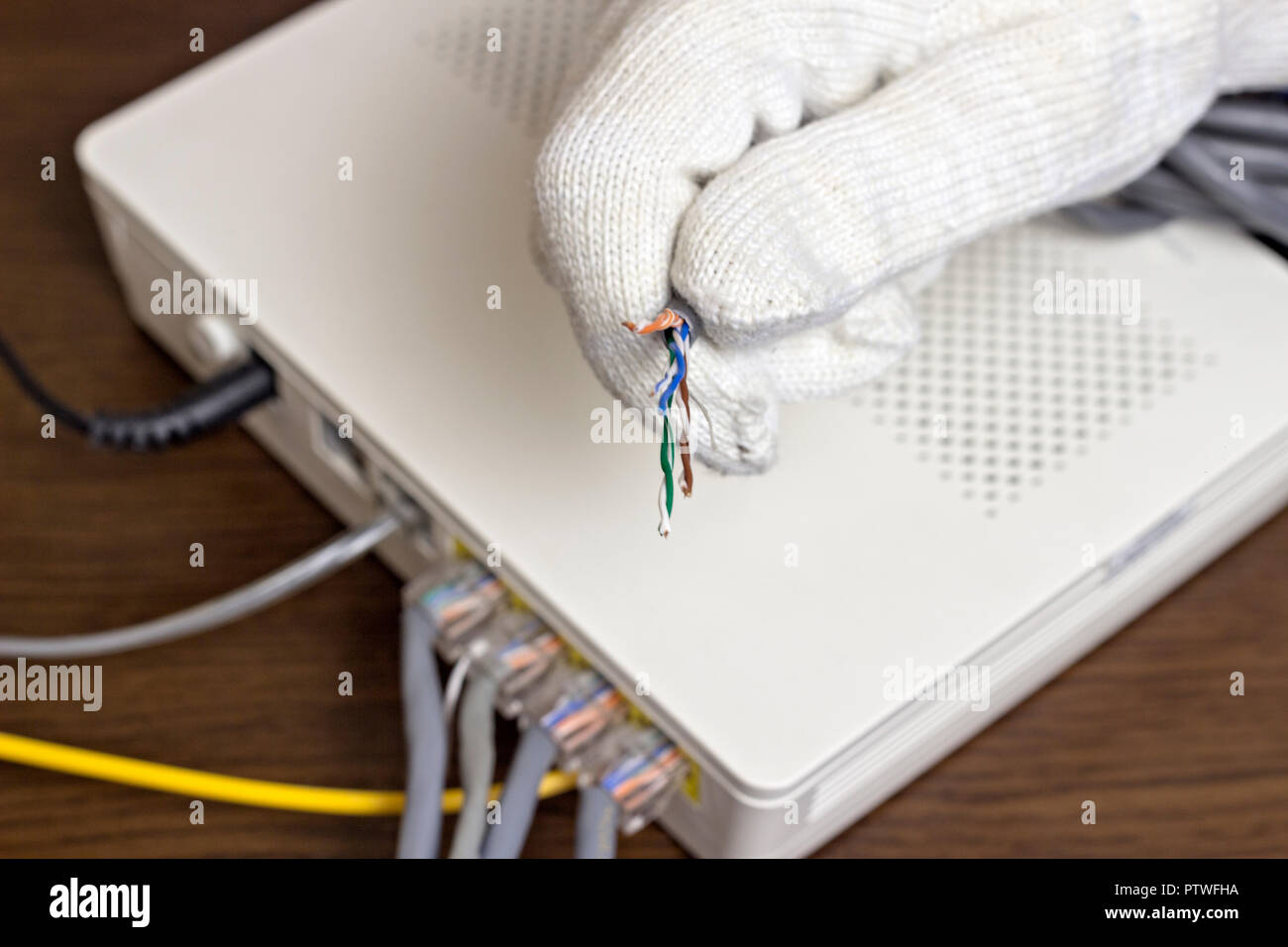 A man holds a network cable in his hand, a close-up, modem and ...