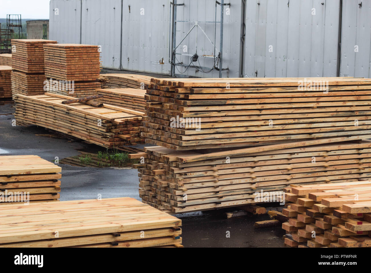 Carefully stacked stacks of wood boards at a woodworking plant ...