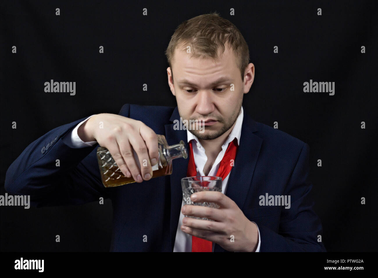 A drunk businessman in a suit with alcohol on a black background Stock ...