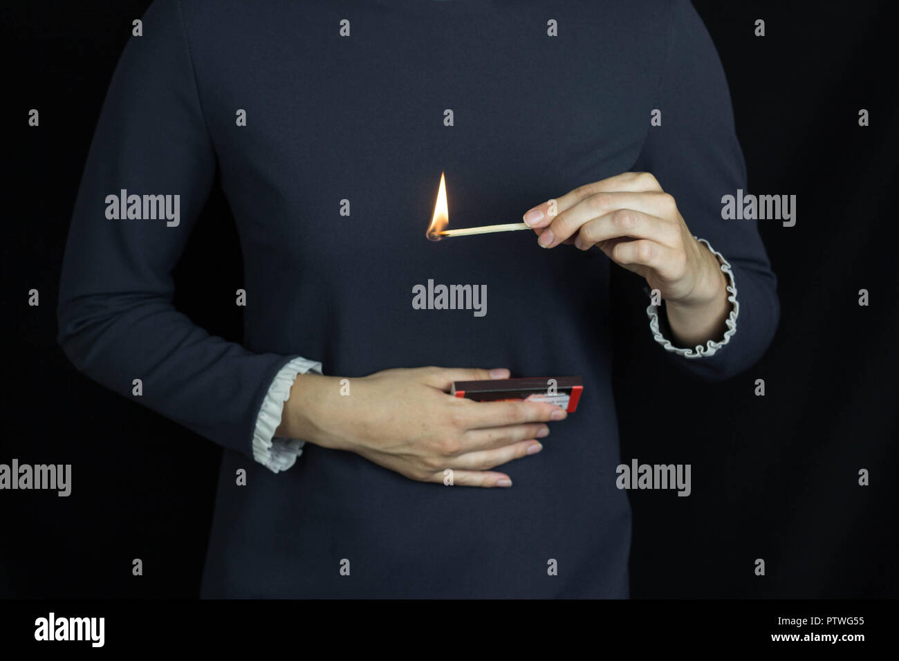 A woman holds onto her stomach, a pain in her stomach, a burning match ...