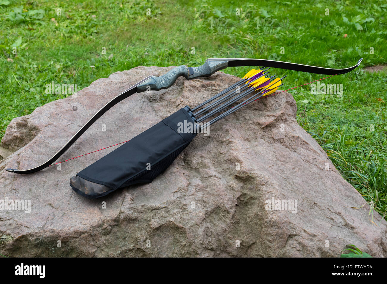 Bow and arrows classic isolated on stone background, toned Stock Photo ...