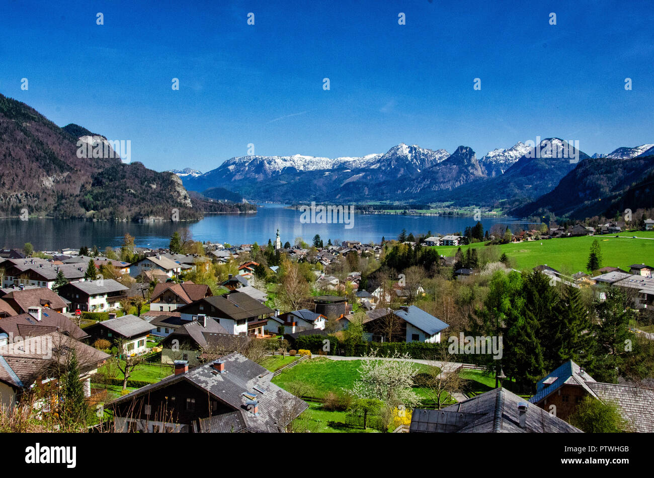 Small Village in the Austrian Alps with a Clear Lake and Distant ...