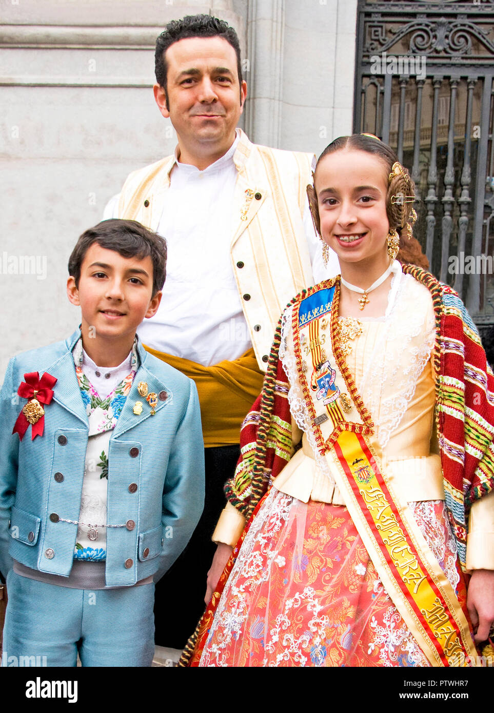 Father with son and daughter dressed in finest traditional clothing at ...