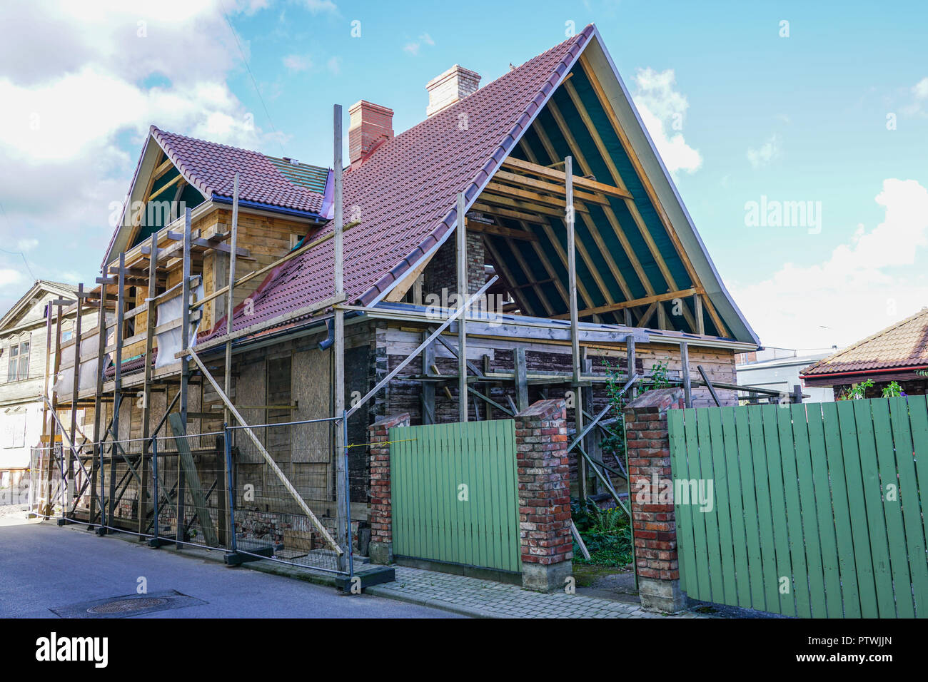 complete reconstruction of old wooden house in city Stock Photo - Alamy
