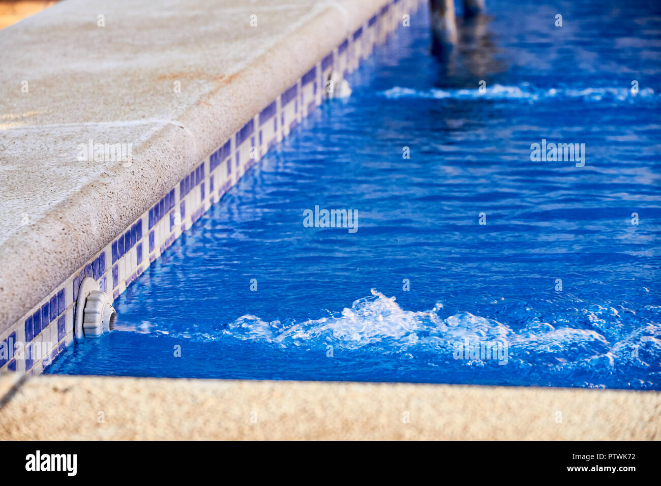 poolside with clear blue water Stock Photo - Alamy