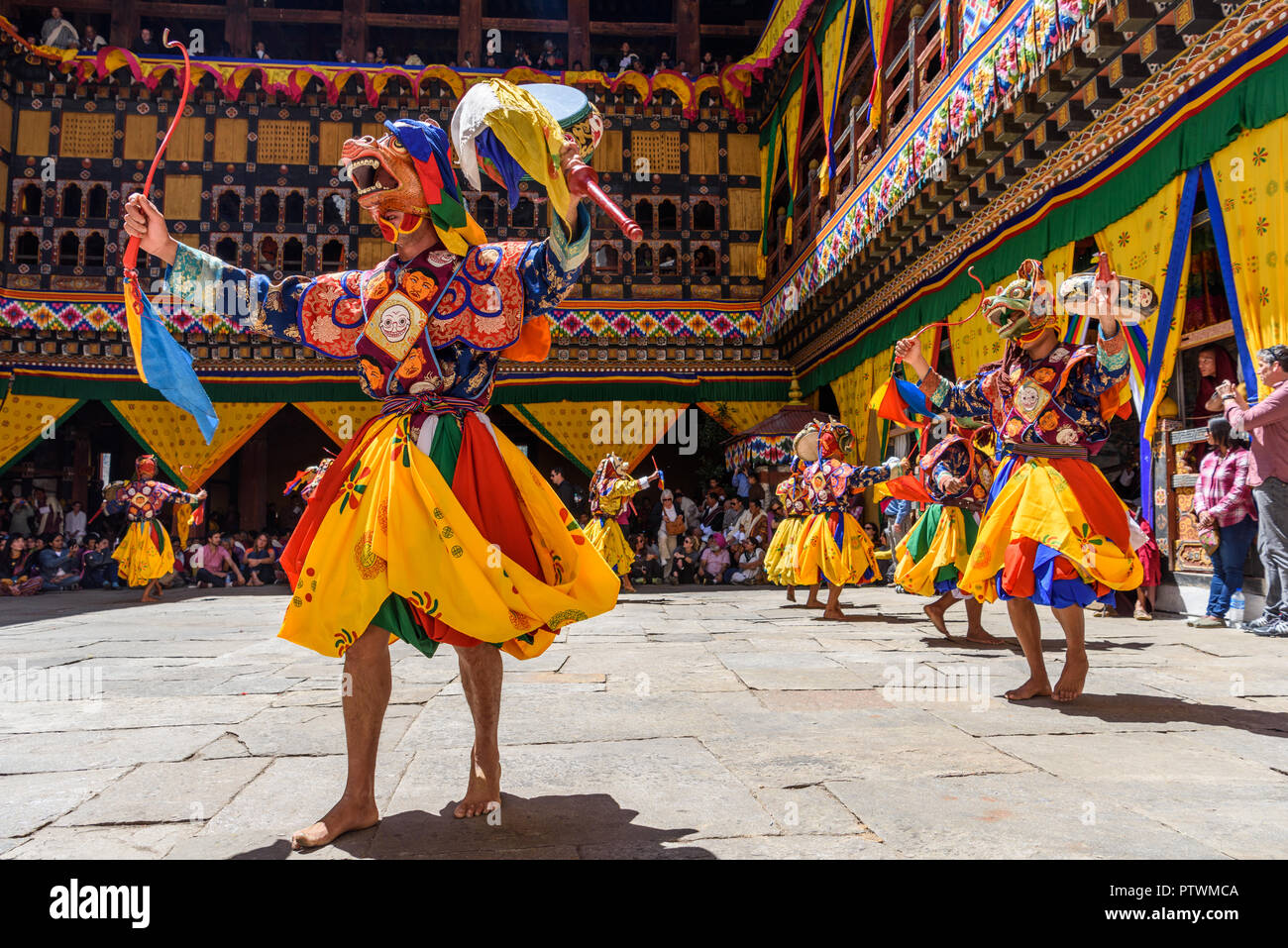 Buddhist Monk dancing and holding a drum at colourful mask dance at ...