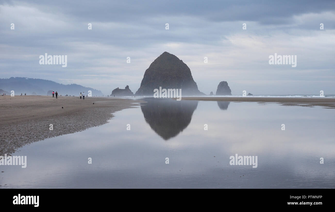 Haystack Rock reflected in the tide pools of Cannon Beach, Oregon at ...